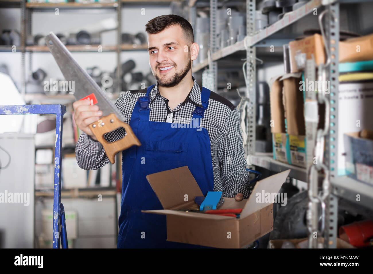 Man worker showing his working tools at workshop Stock Photo - Alamy