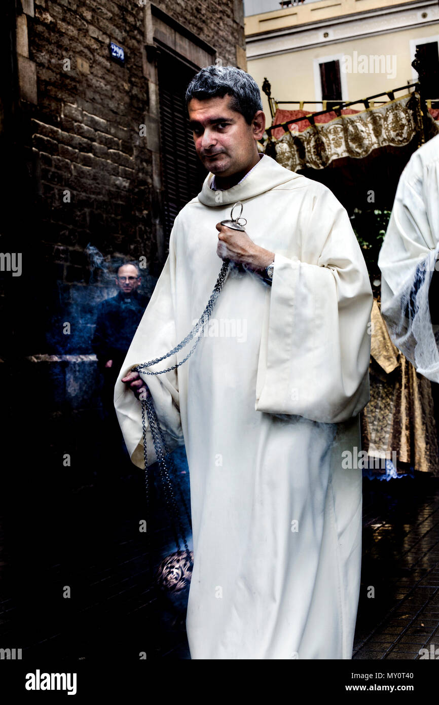 Catholic priest purifying the air during a communion ceremony ...