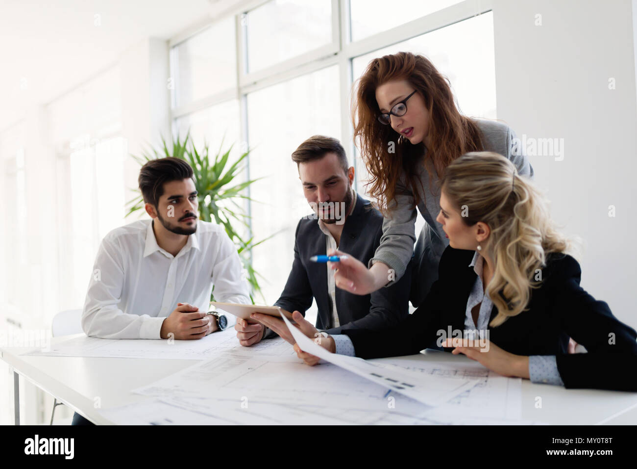 Group of architects working together on project Stock Photo - Alamy