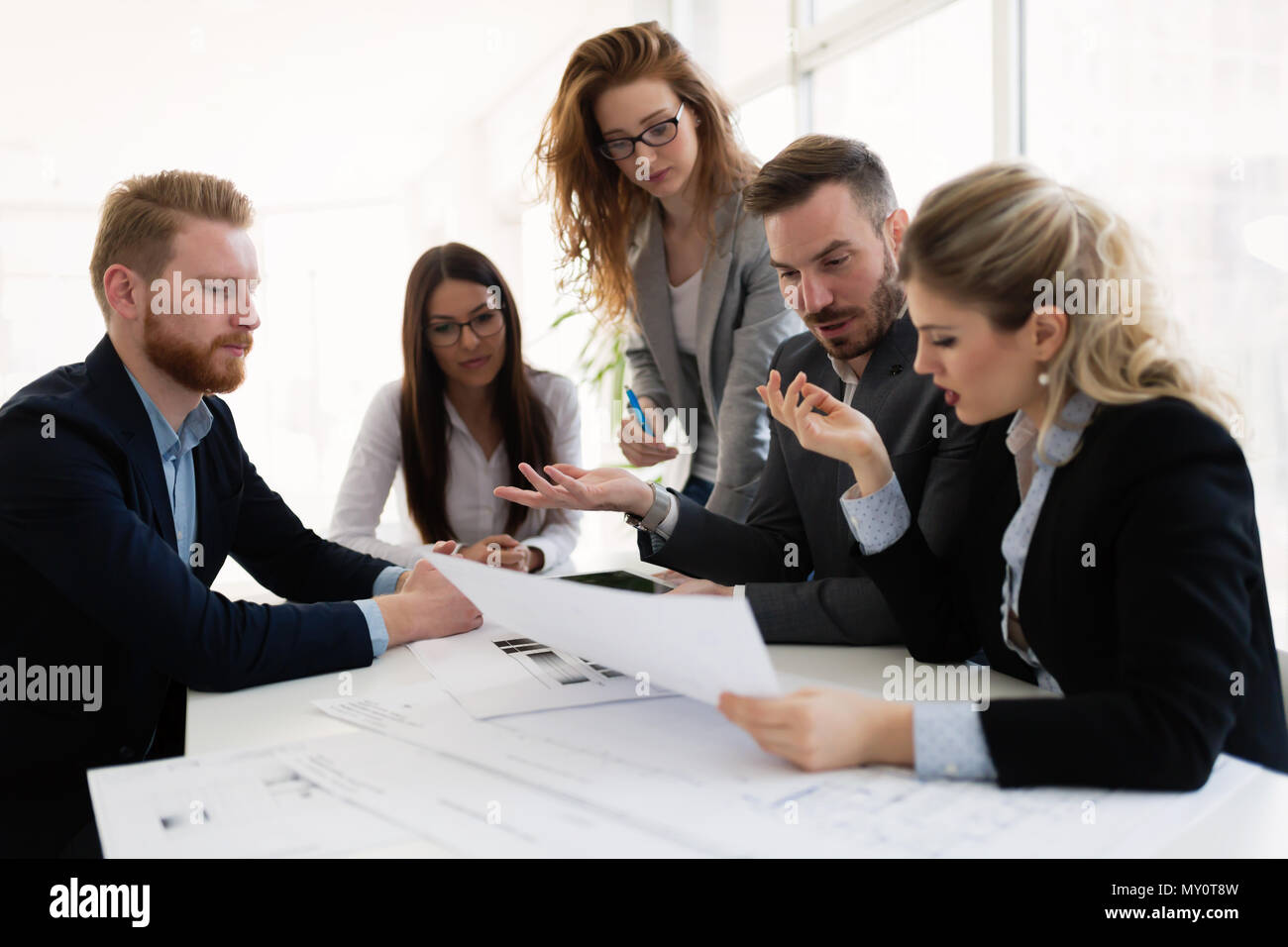 Group of architects working together on project Stock Photo - Alamy