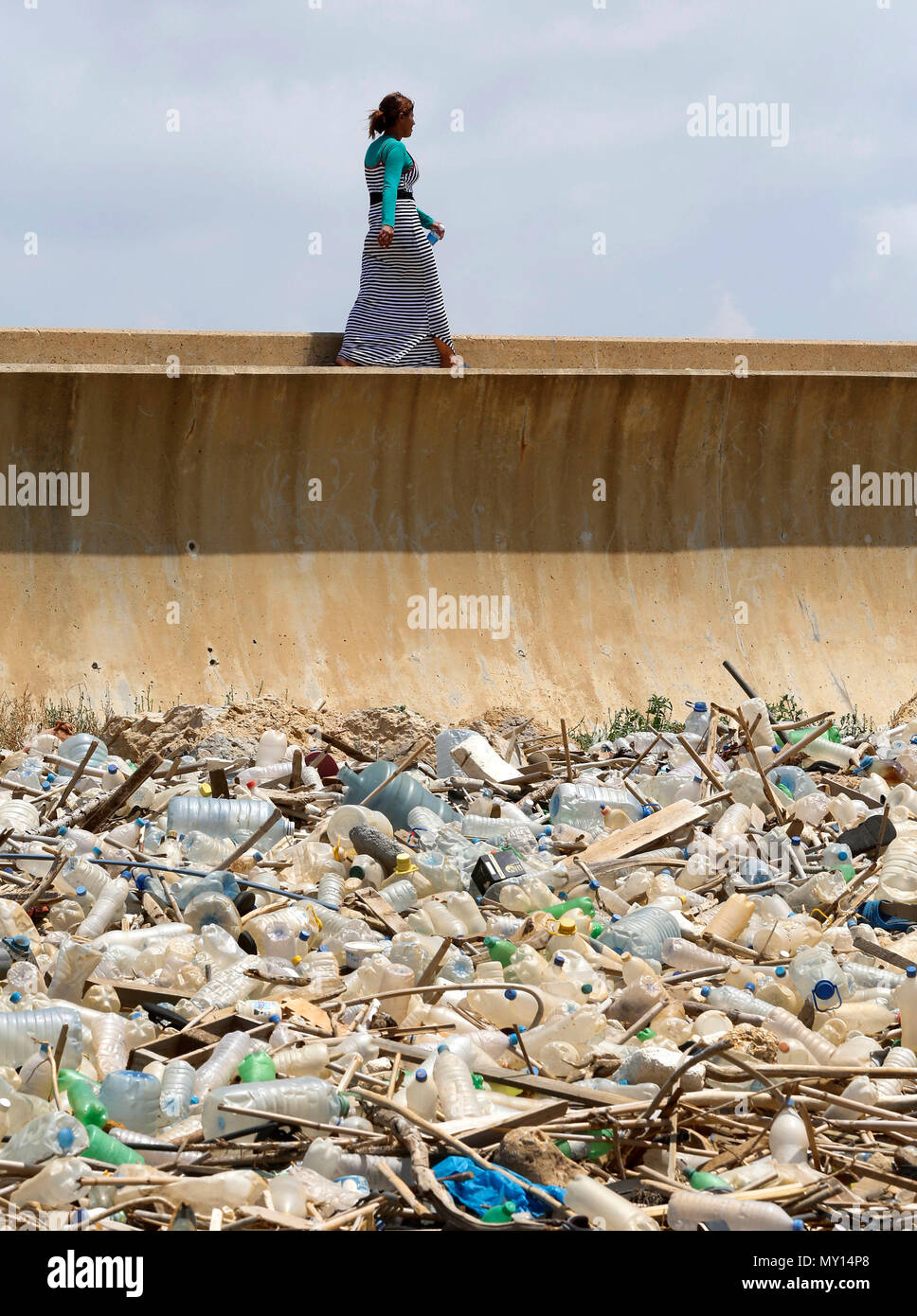 Beirut, Lebanon. 5th June, 2018. A woman walks past rubbish on a sea ...