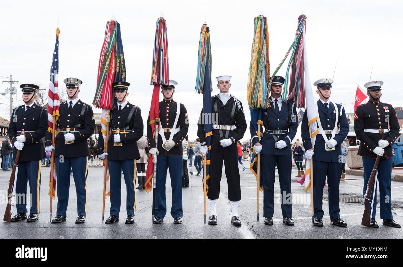 Members of a Joint Service Color Guard prepare to participate in a ...