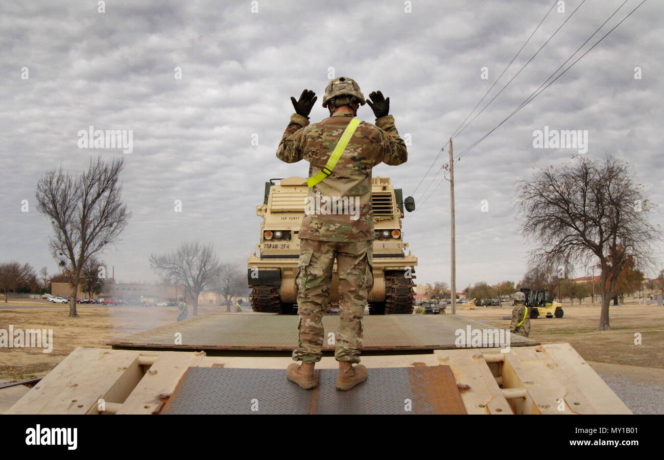 An A Battery, 2nd Battalion, 4th Field Artillery Soldier gives hand ...