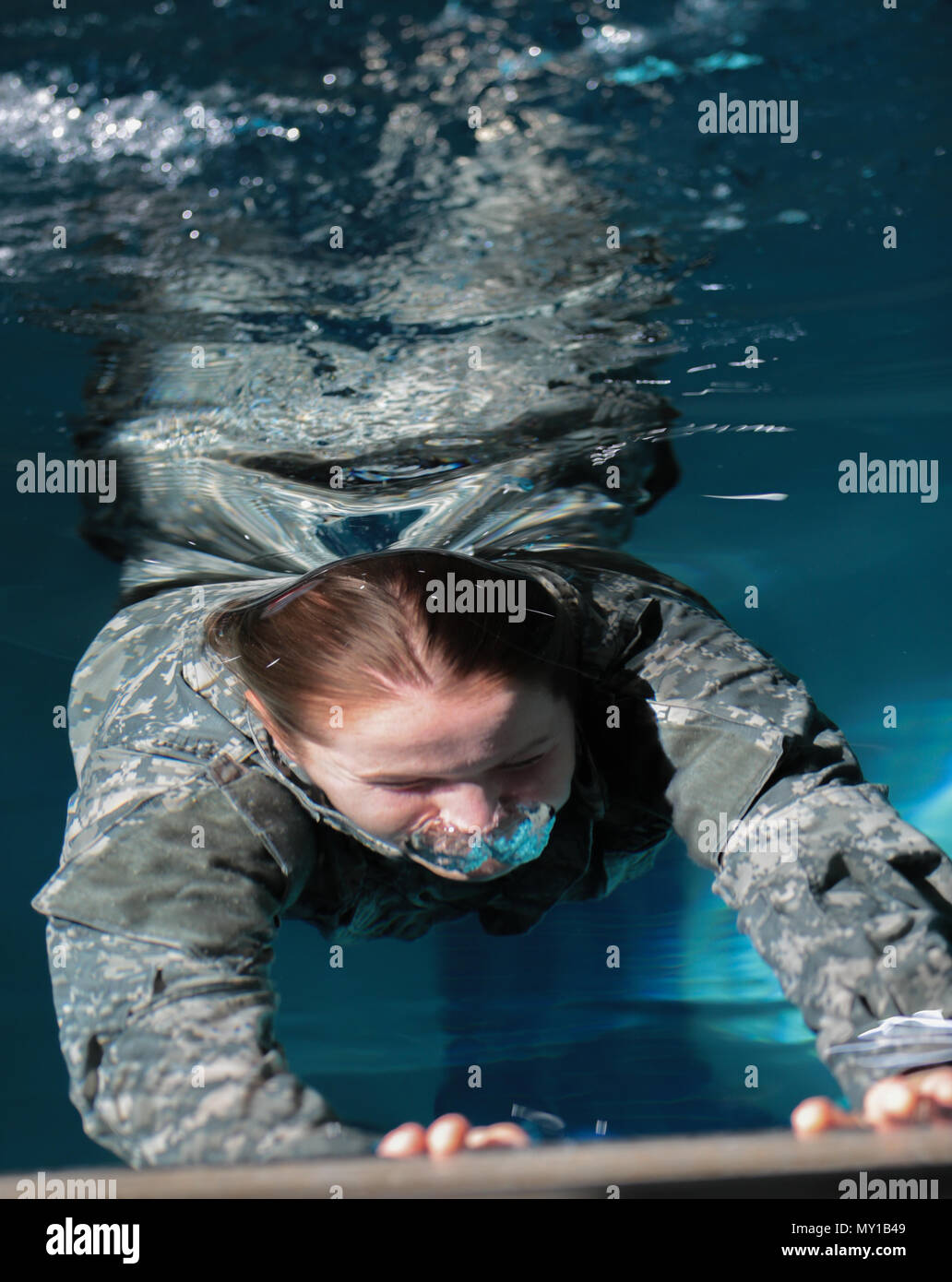 U.S. Army Sgt. Mara Manning surfaces during the swimming portion of the ...