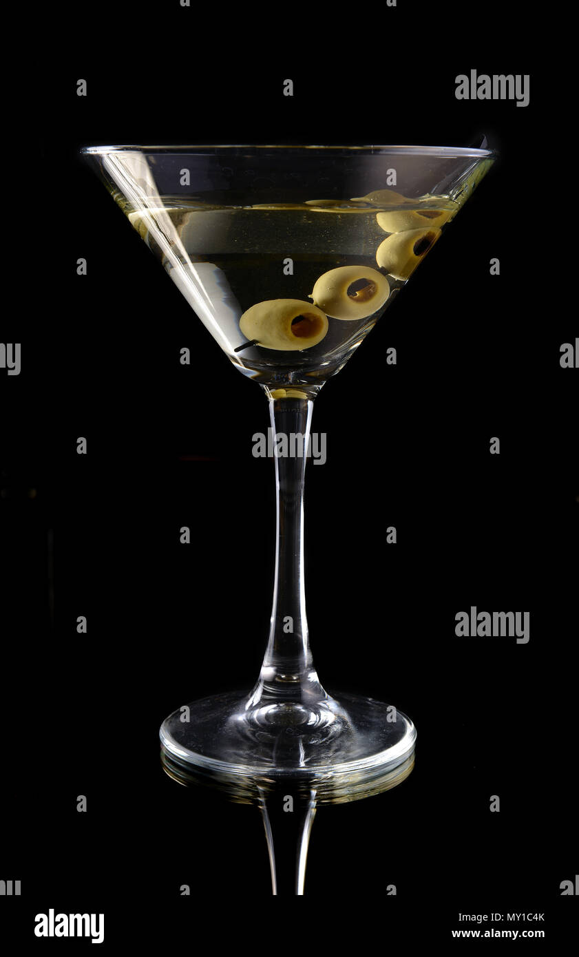 Martini with olives on a black background Stock Photo - Alamy