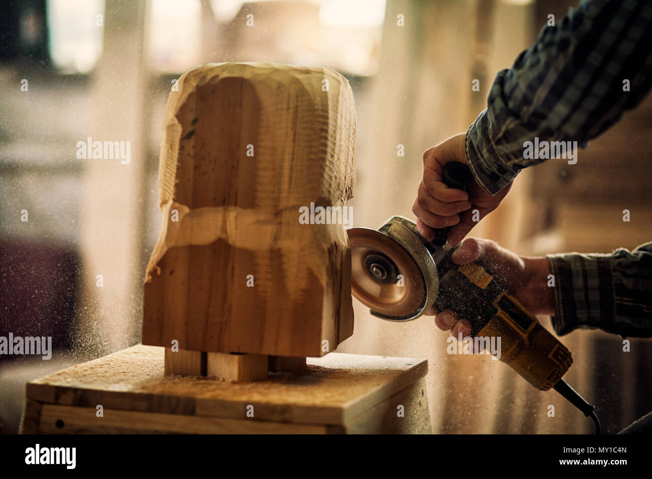 Close up of a carpenter in work clothes and small buiness owner working ...
