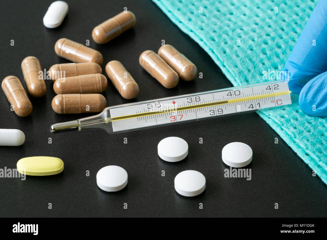 Traditional medical thermometer for measuring body temperature in hand ...