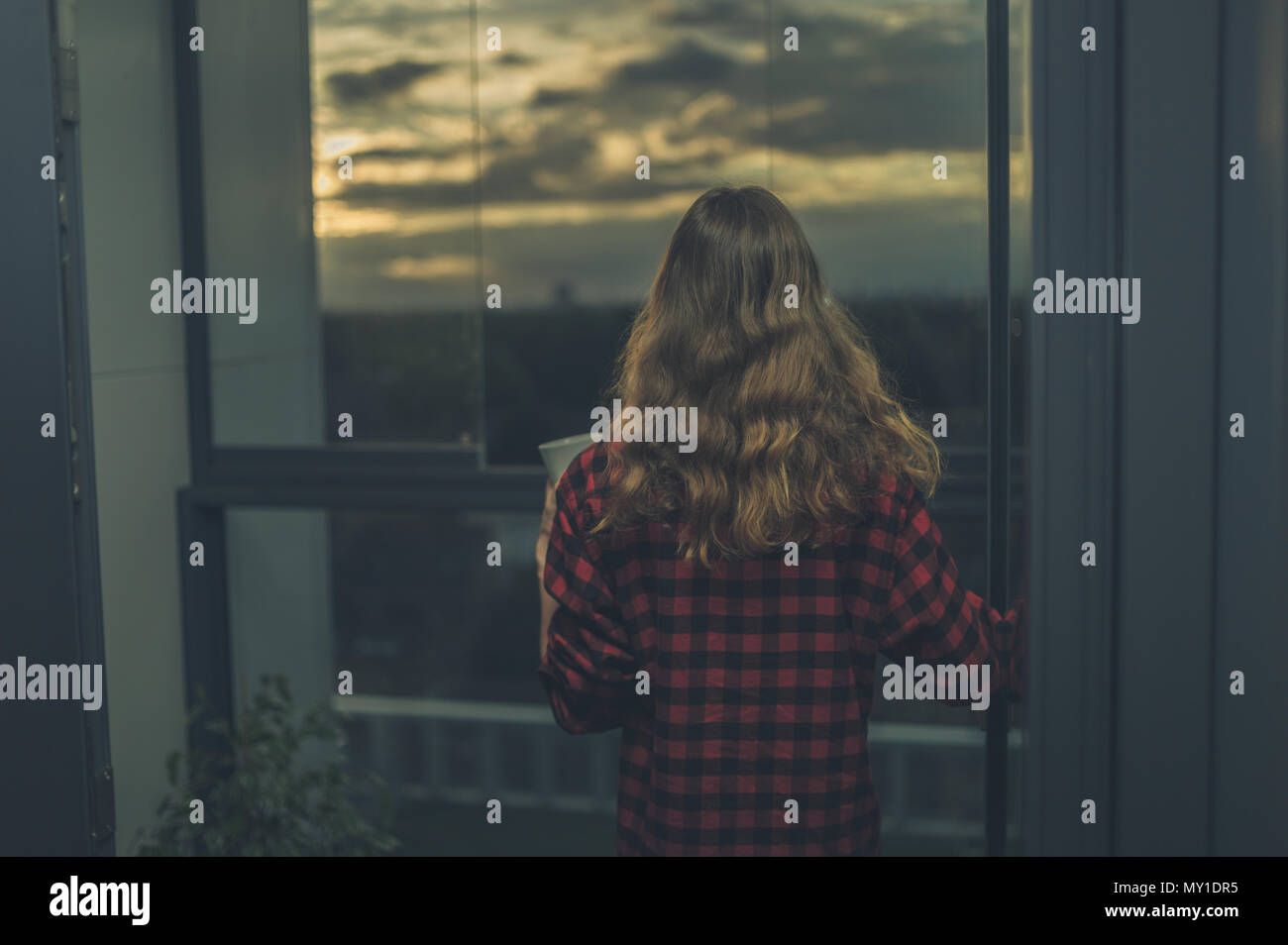 Person standing on balcony flat hi-res stock photography and images - Alamy