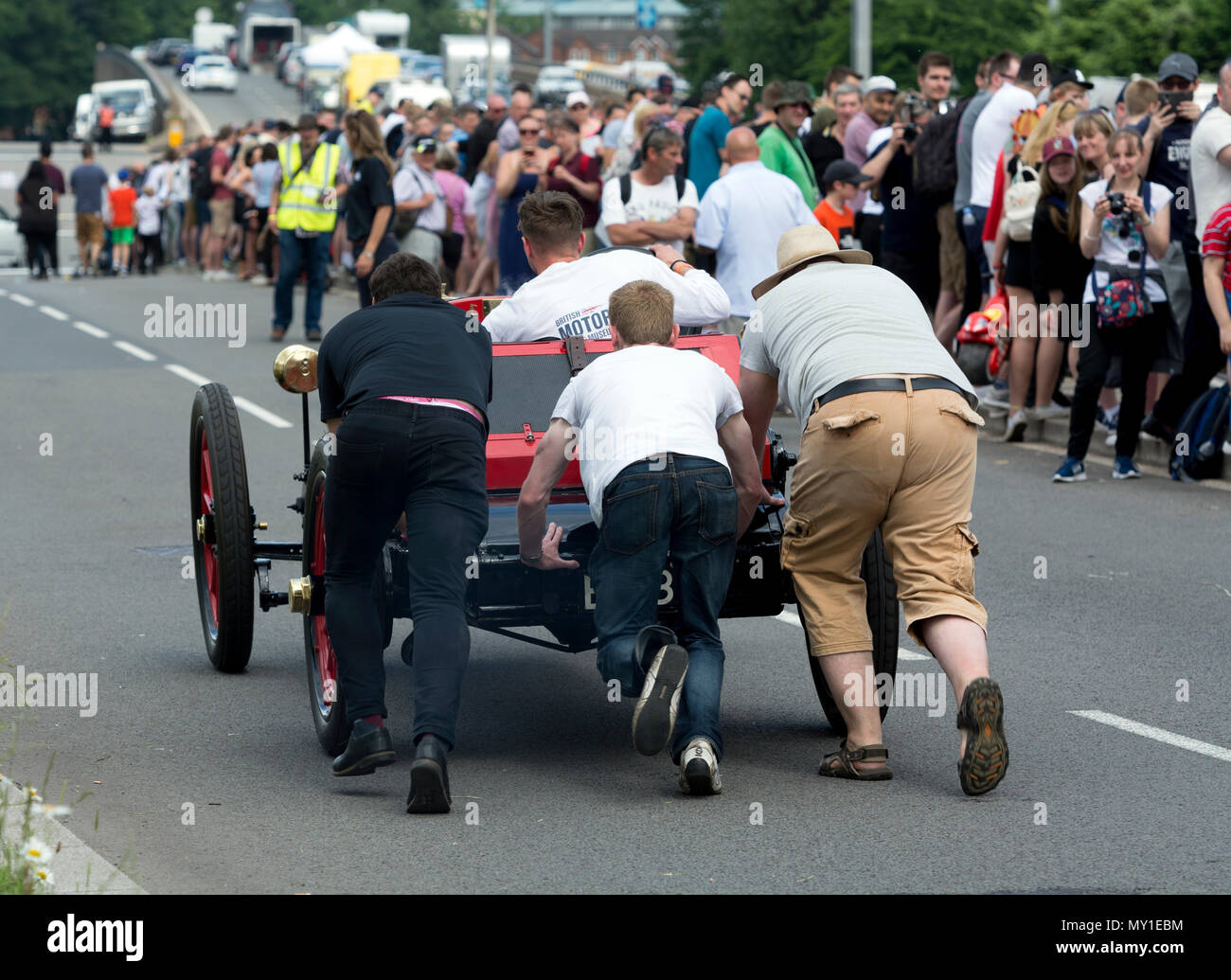 Men pushing a vintage car Stock Photo - Alamy