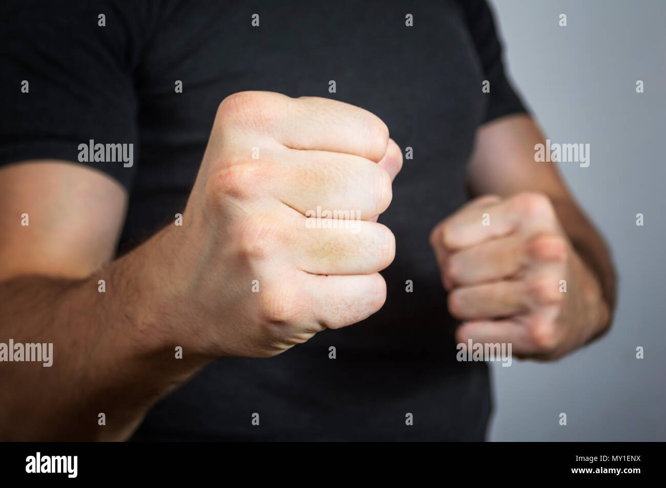Caucasian man with a threatening gesture, ready to punch or fight with ...