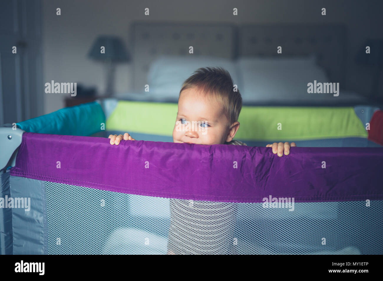 Baby looking over crib hi-res stock photography and images - Alamy