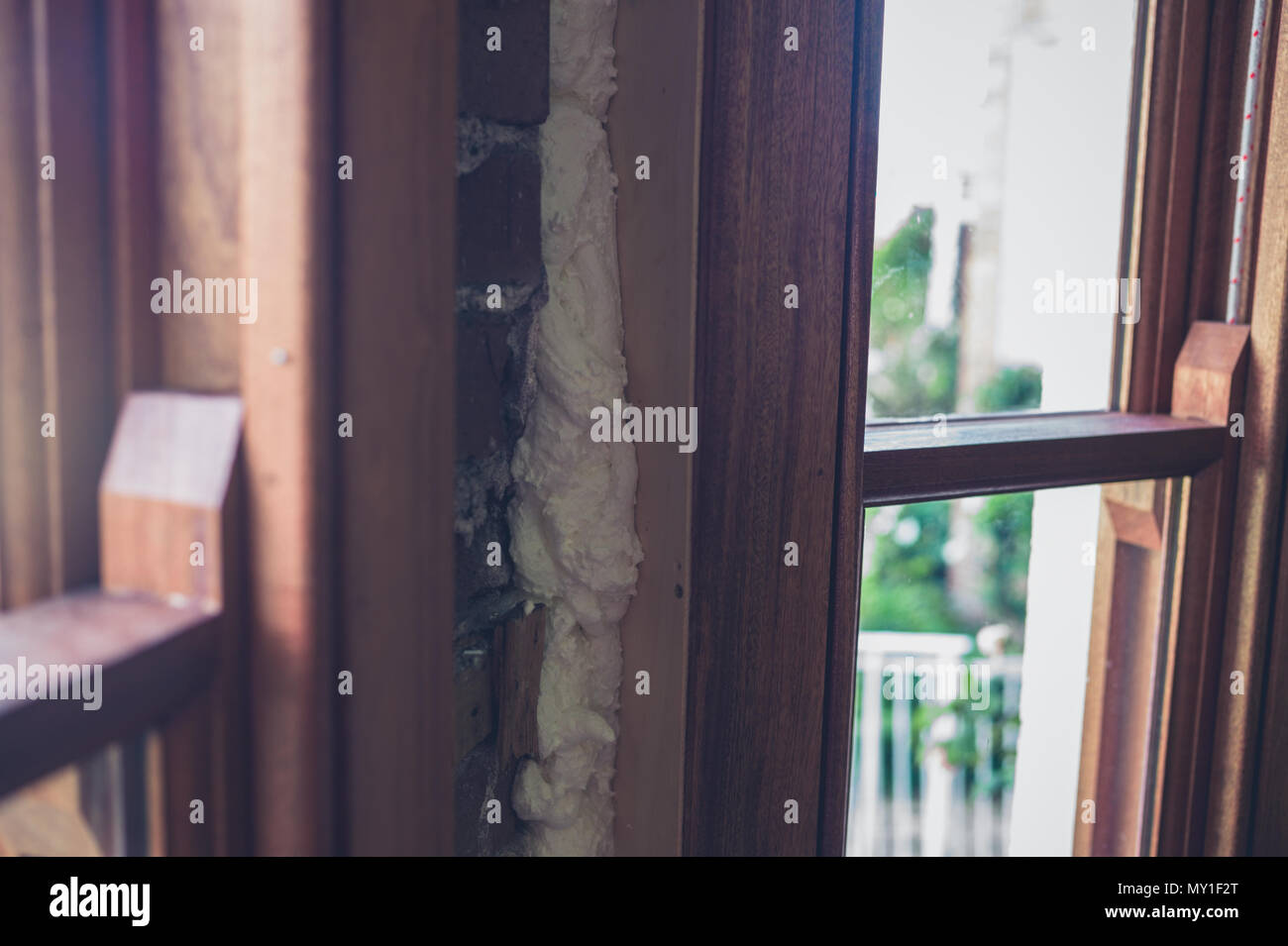 New windows being fitted with expanding foam Stock Photo - Alamy