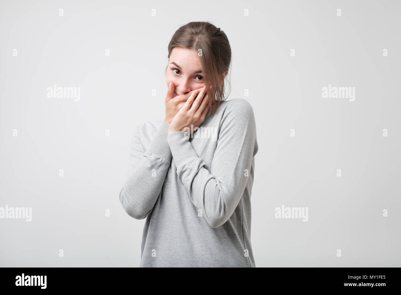 Lovely And Sensual Caucasian Female Being Shy Holding Hands Near Chin