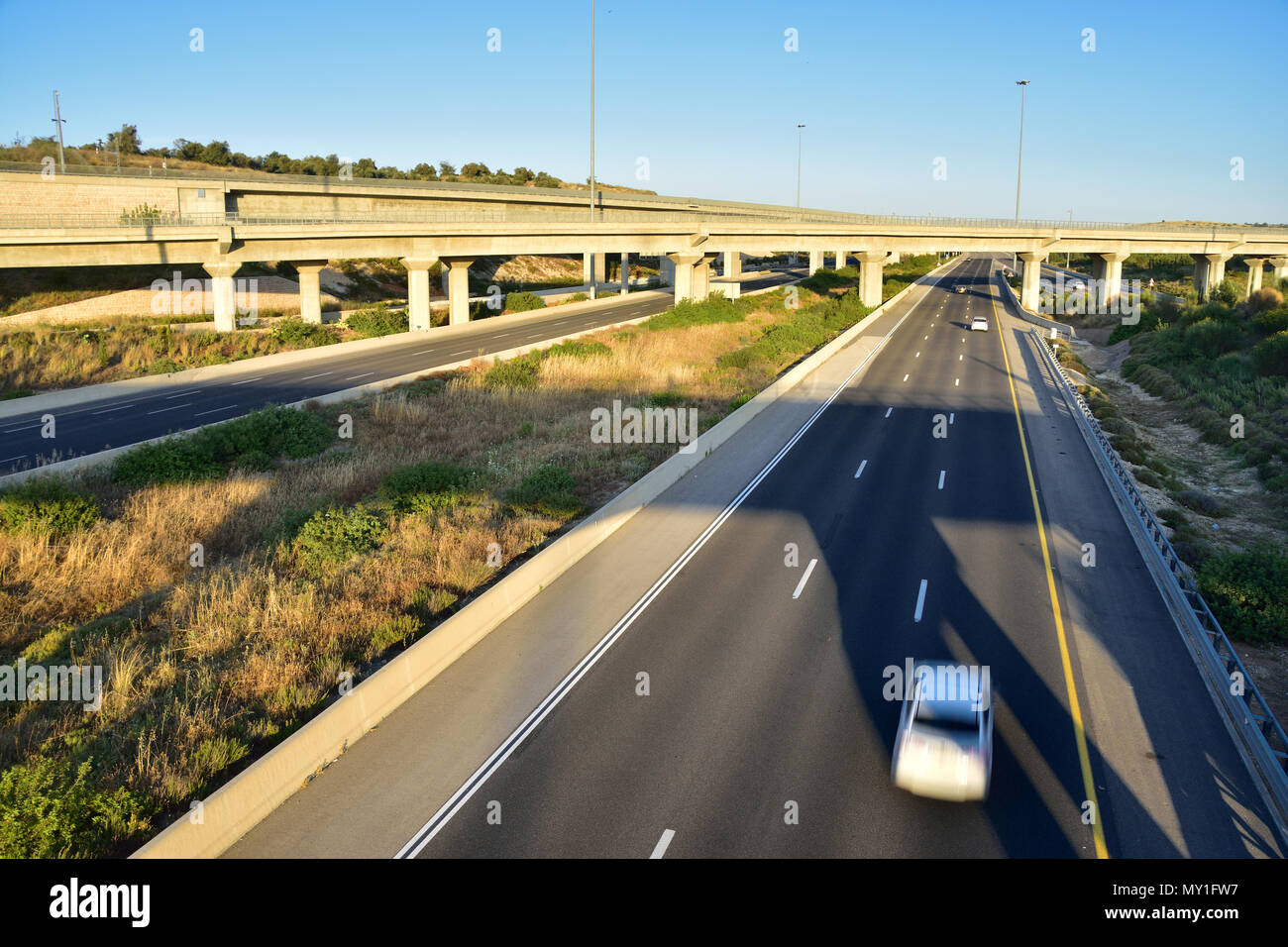 View of landscape with two way highway under evening light. Central ...