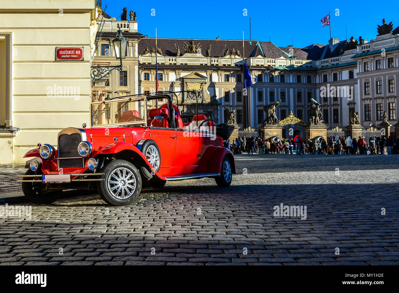 Vintage red car with the Prague Castle in the background. These are ...