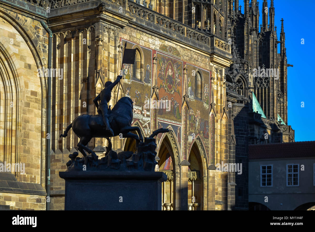 Statue of Saint George with St. Vitus Cathedral Golden Gate in the ...