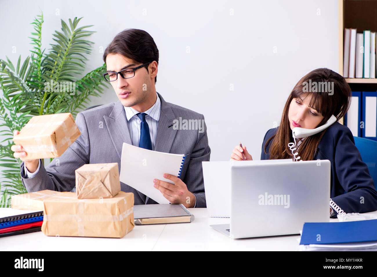 Business people receiving new mail and parcels Stock Photo - Alamy