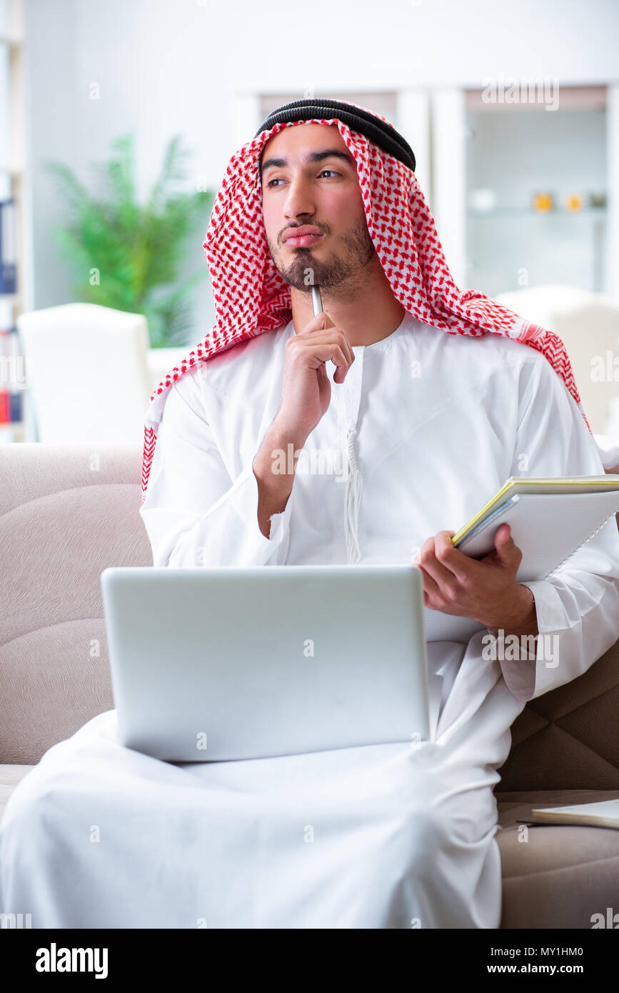 Arab man working at home on his work Stock Photo - Alamy