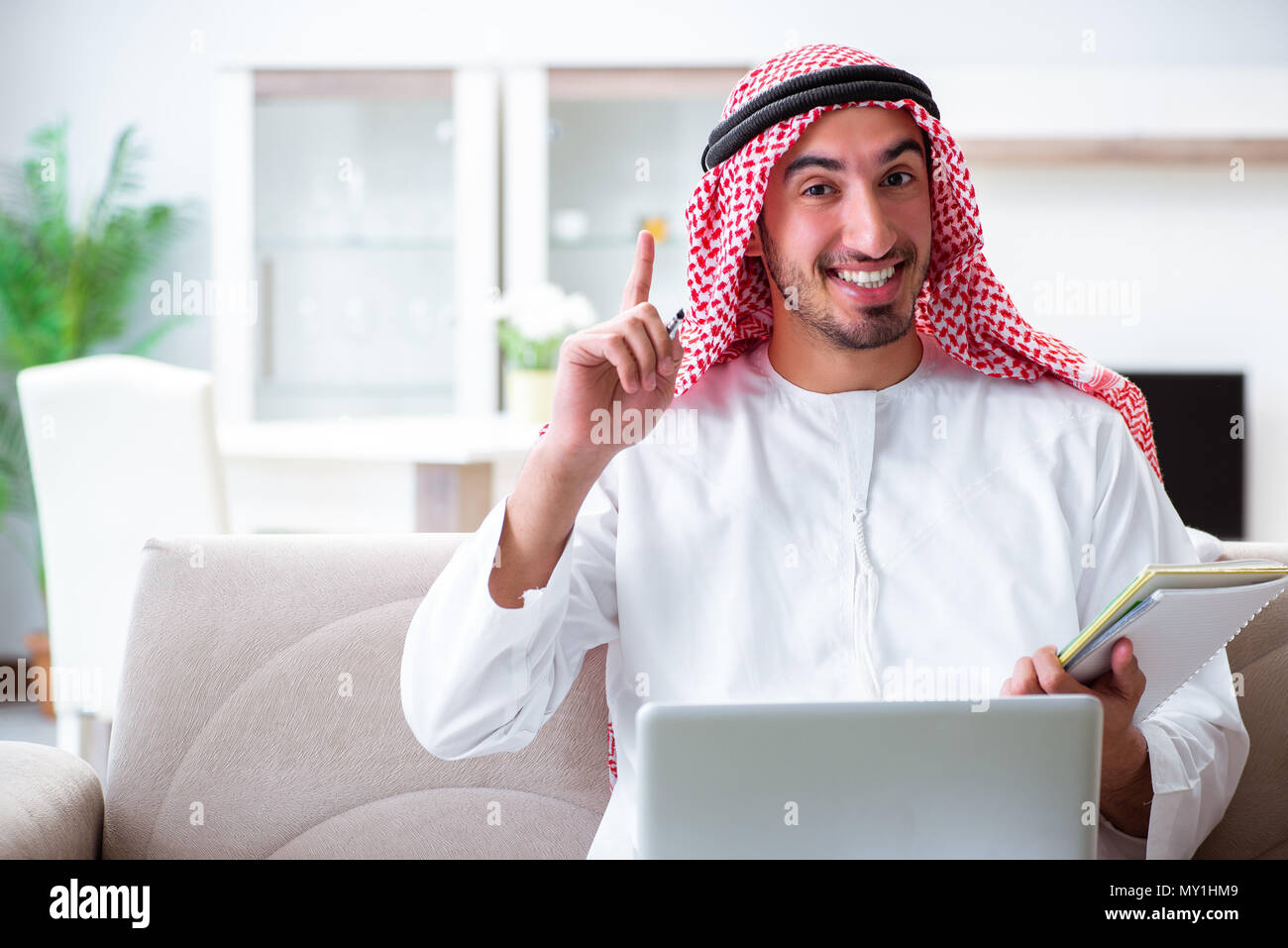 Arab man working at home on his work Stock Photo - Alamy