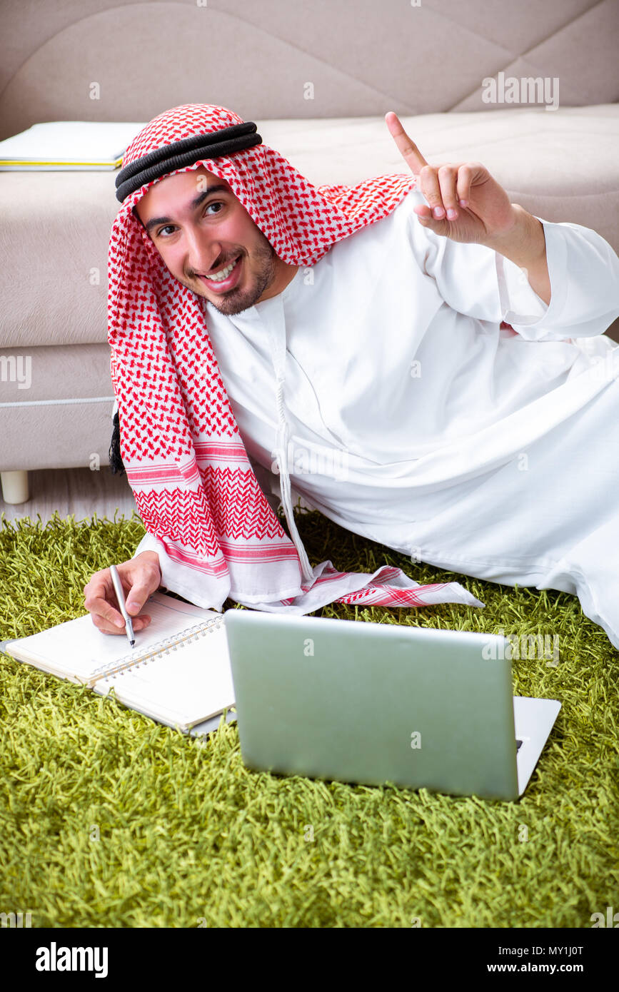 Arab man working at home on his work Stock Photo - Alamy