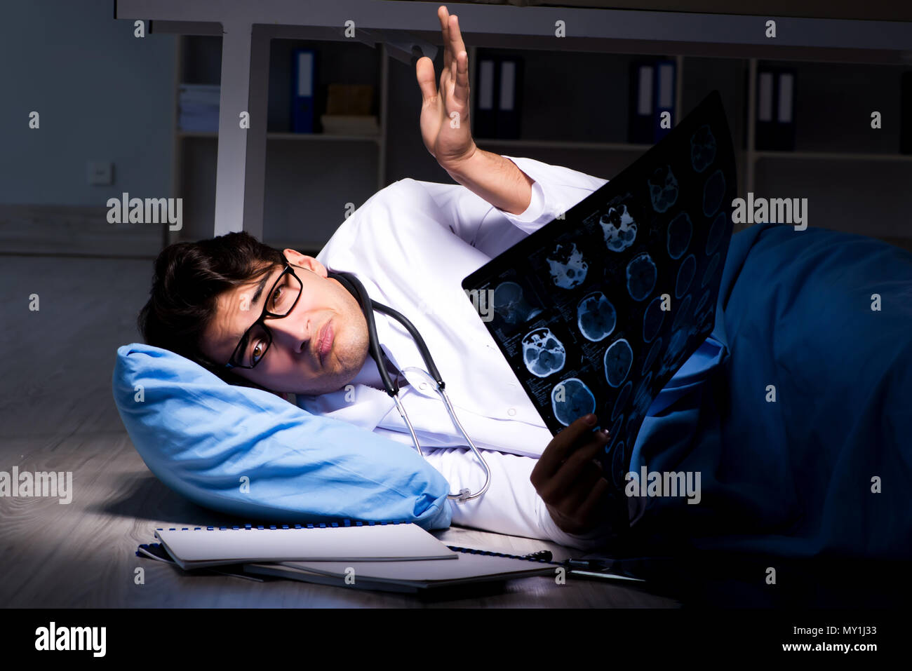 Doctor working night shift in hospital after long hours Stock Photo - Alamy