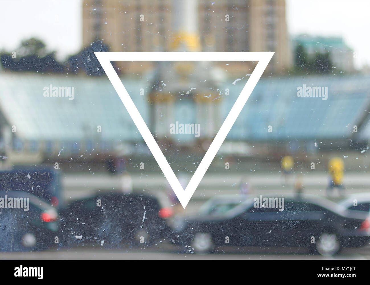 White flat triangle on blurry day city background Stock Photo - Alamy