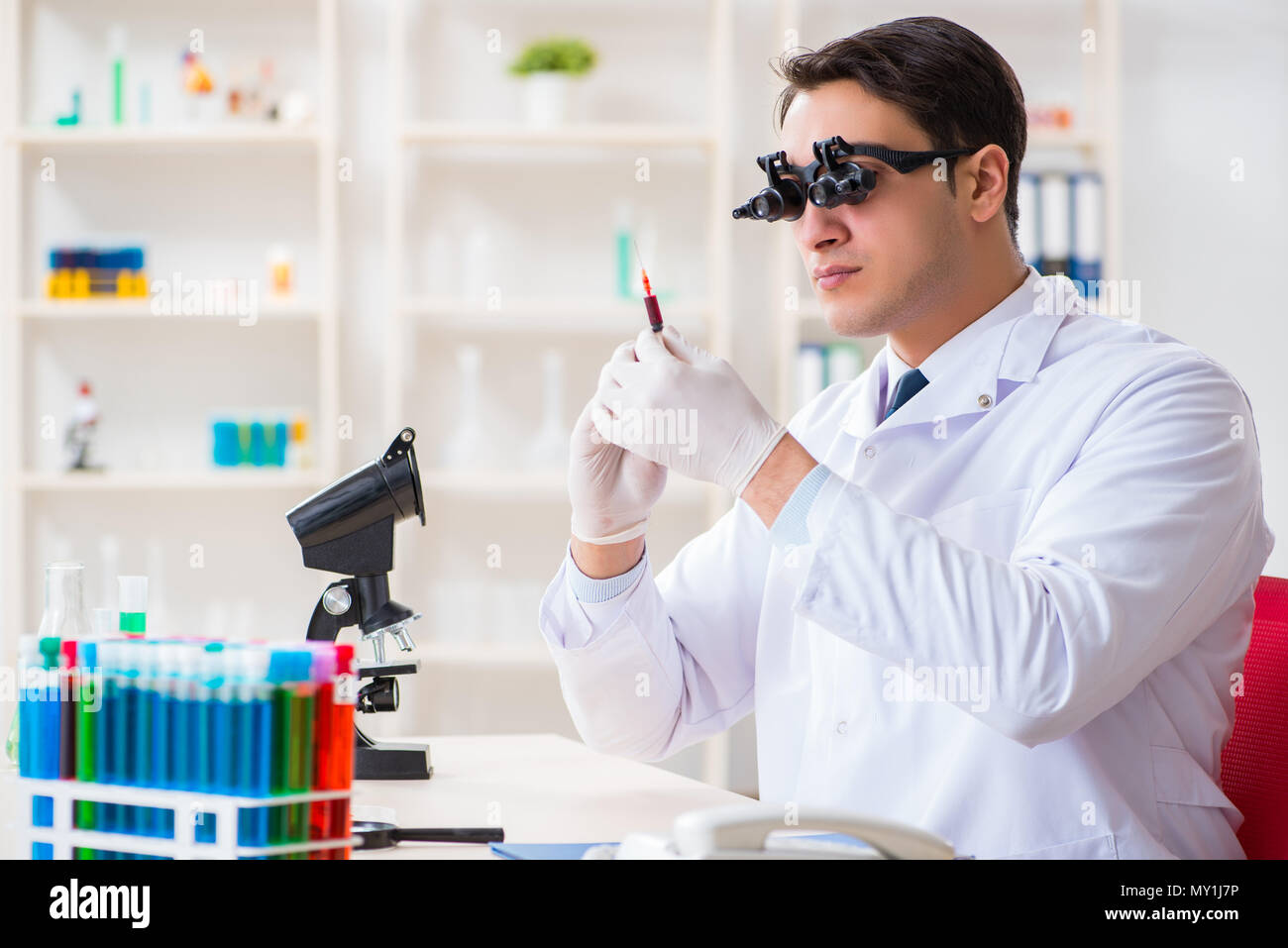 Doctor chemist working on blood samples in lab Stock Photo - Alamy