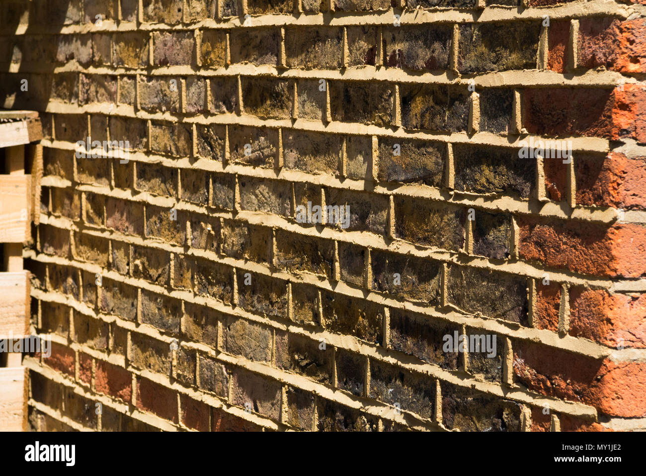 A brick end of terrace wall which has re-pointed by a builder ...