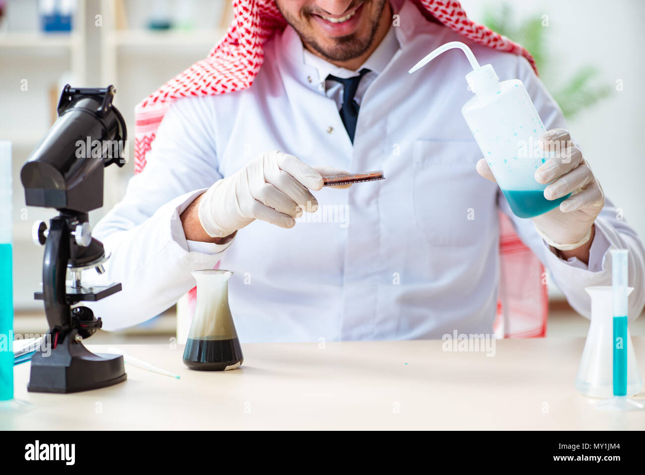 Arab chemist working in the lab office Stock Photo - Alamy