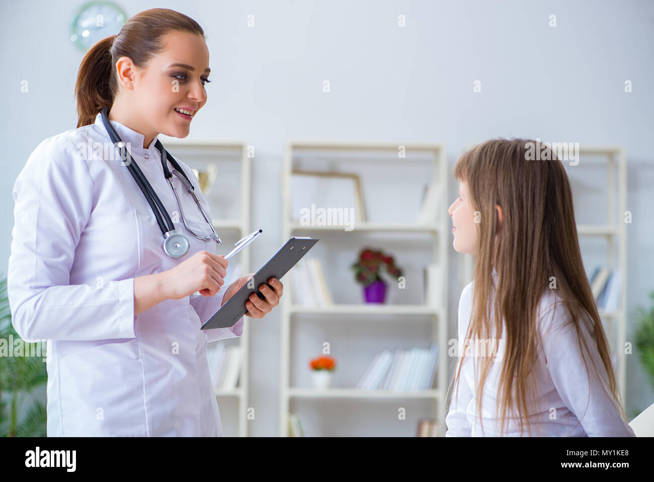 Female doctor pediatrician checking girl Stock Photo - Alamy