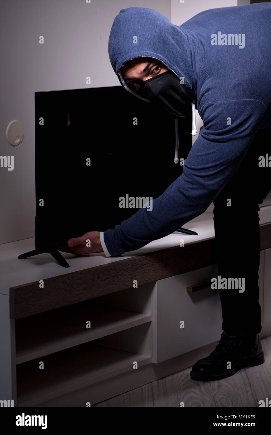 Burglar thief stealing tv from apartment house Stock Photo - Alamy