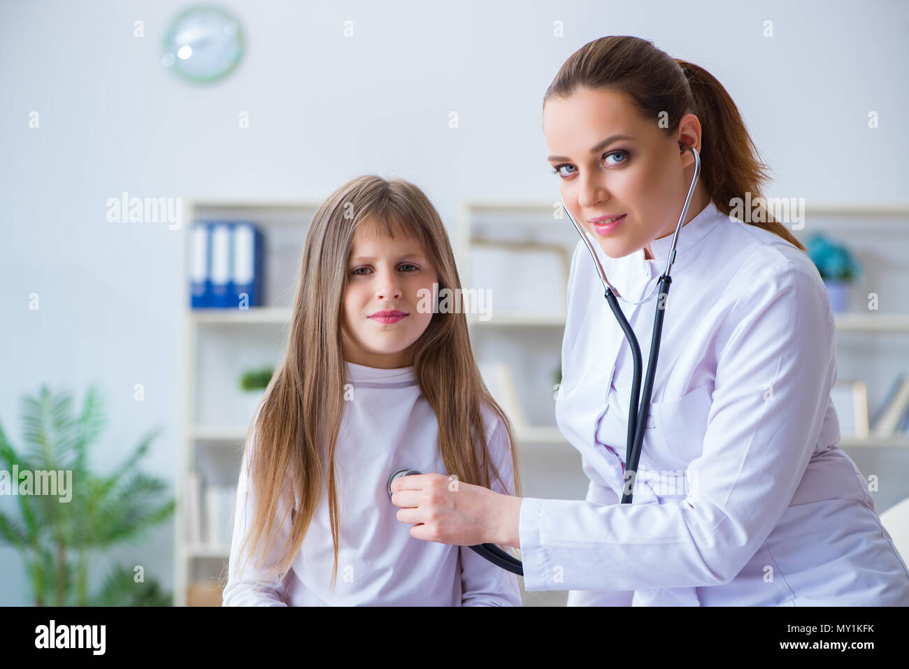 Female doctor pediatrician checking girl Stock Photo - Alamy