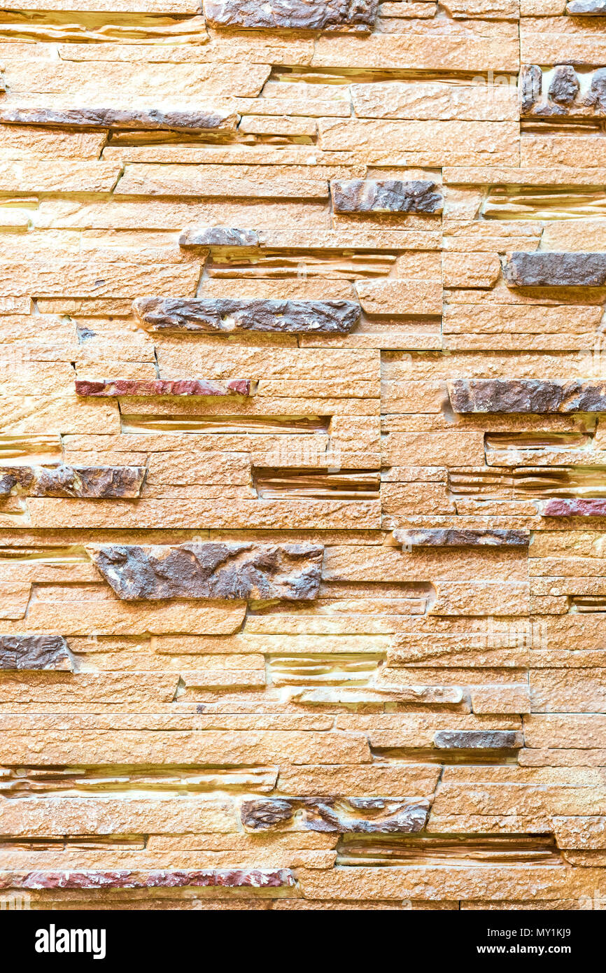Wall made of decorative brown stone. Background Stock Photo - Alamy