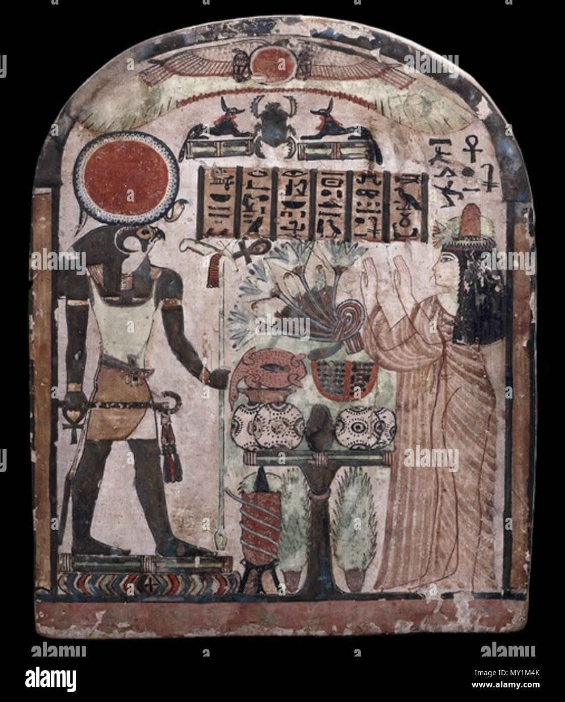 . English: Wooden stele depicting Deniuenkhonsu worshipping Ra before a ...