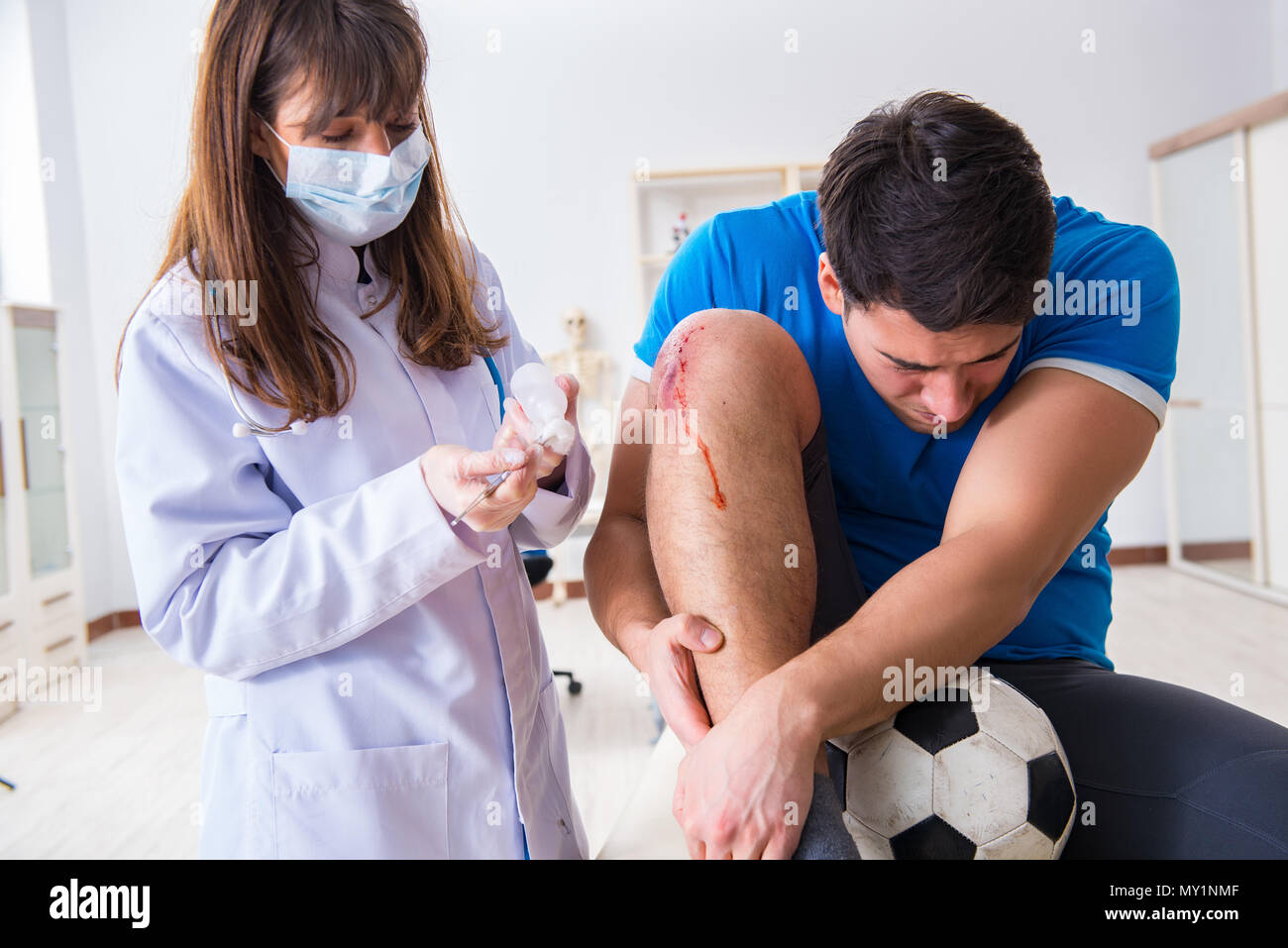 Football soccer player visiting doctor after injury Stock Photo - Alamy