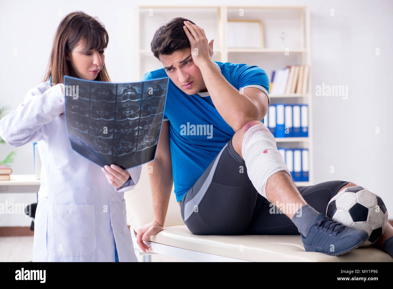 Football soccer player visiting doctor after injury Stock Photo - Alamy