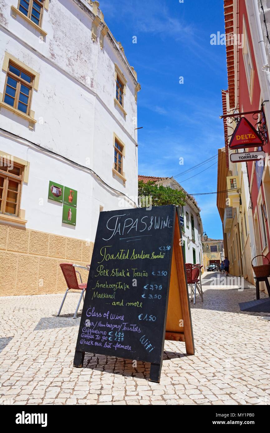 Tapas menu board on the pavement outside a cafe along Rua da Porta de ...