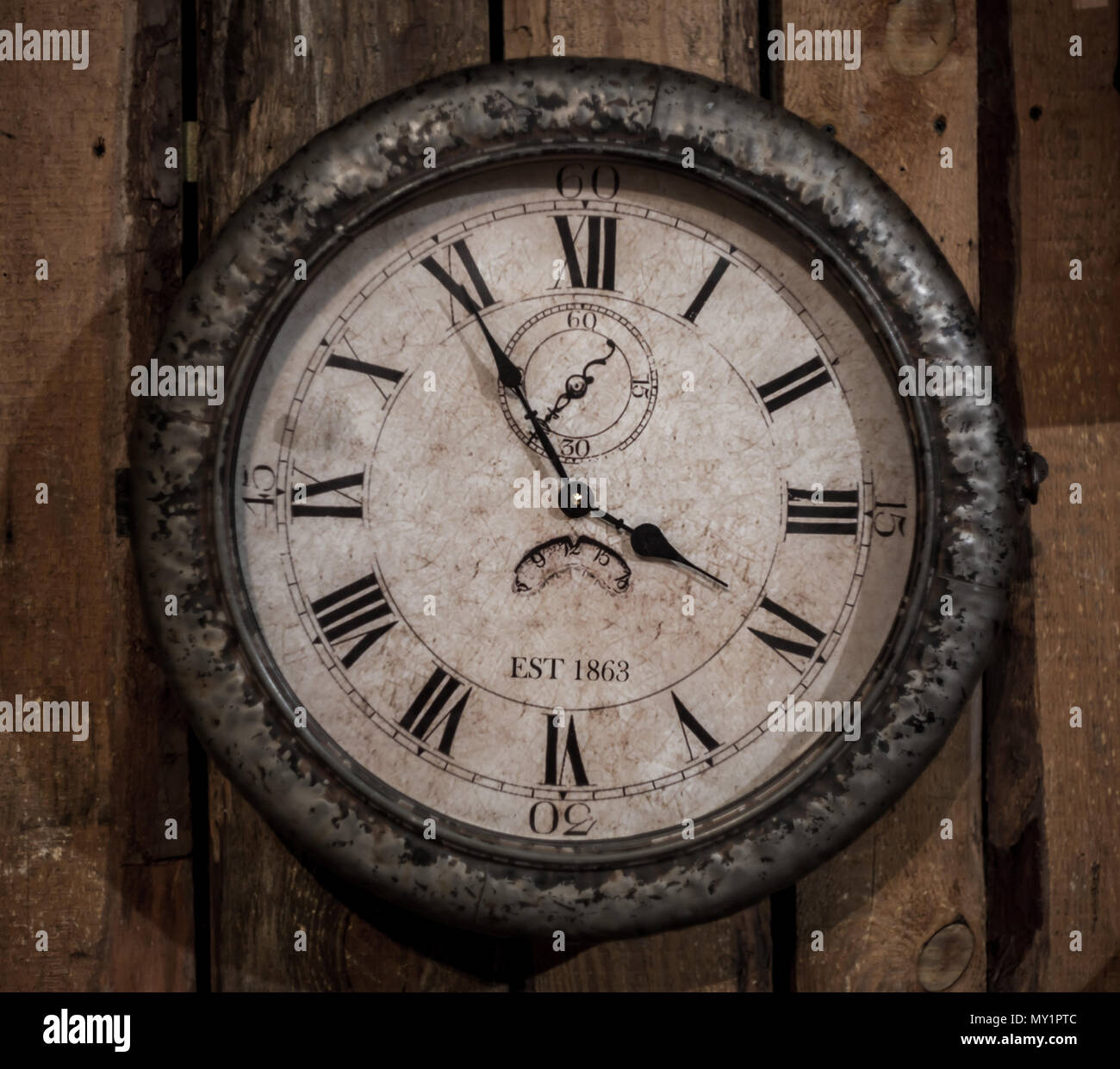 small retro clock hanging on wooden wall Stock Photo - Alamy