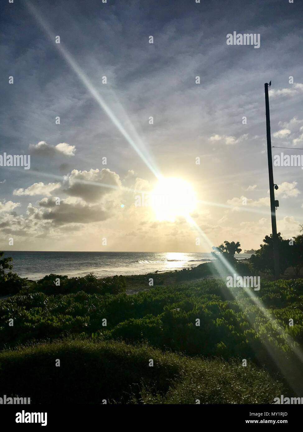Sunset at a coastal street in Oistins, Barbados (Caribbean Island) with ...