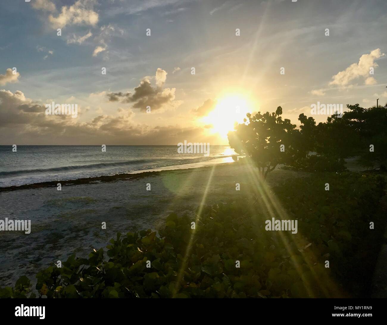 Sunset at a coastal street in Oistins, Barbados (Caribbean Island) with ...