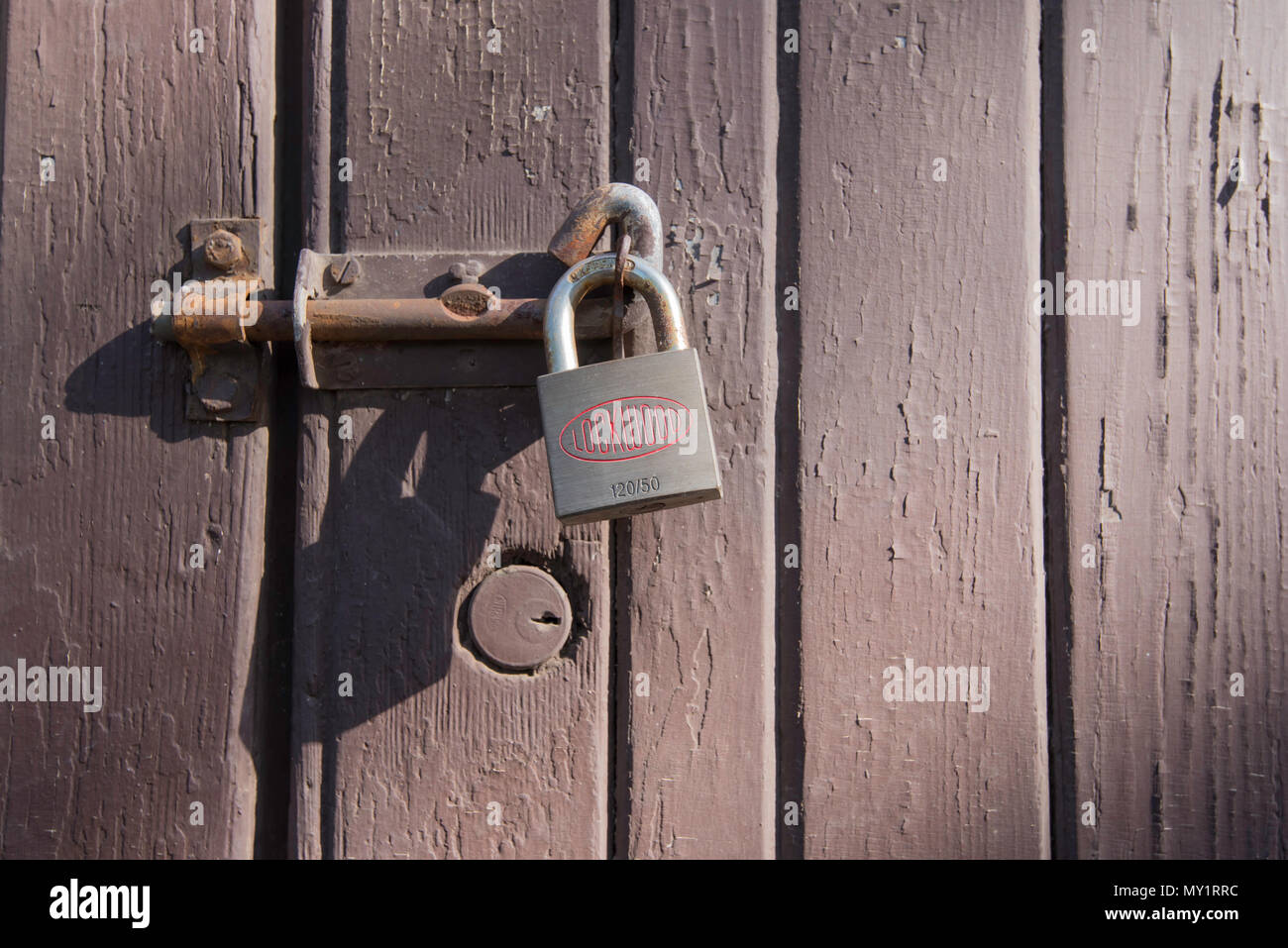 Old wooden outside door and metal slide latch hi-res stock photography ...