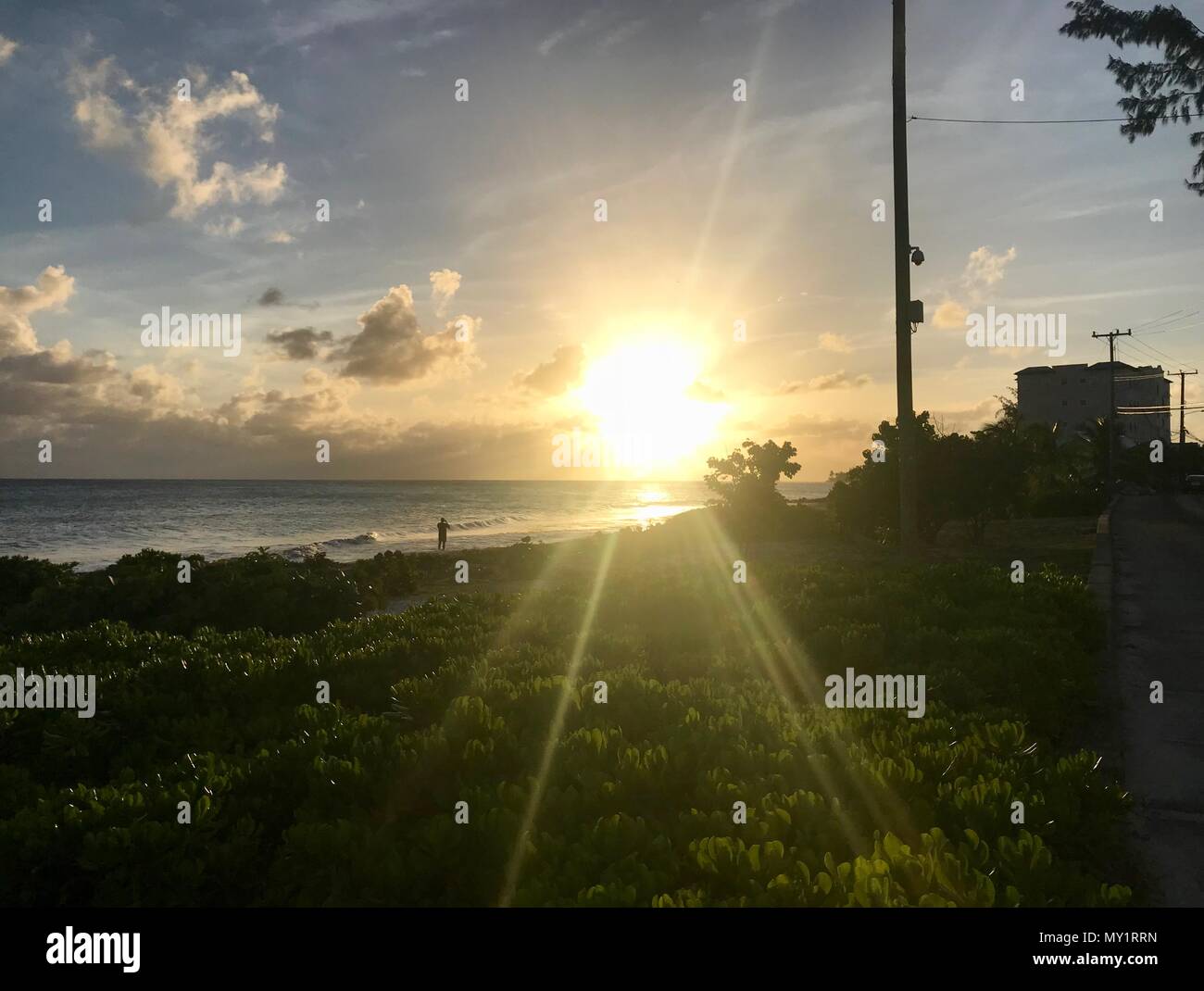 Sunset at a coastal street in Oistins, Barbados (Caribbean Island) with ...