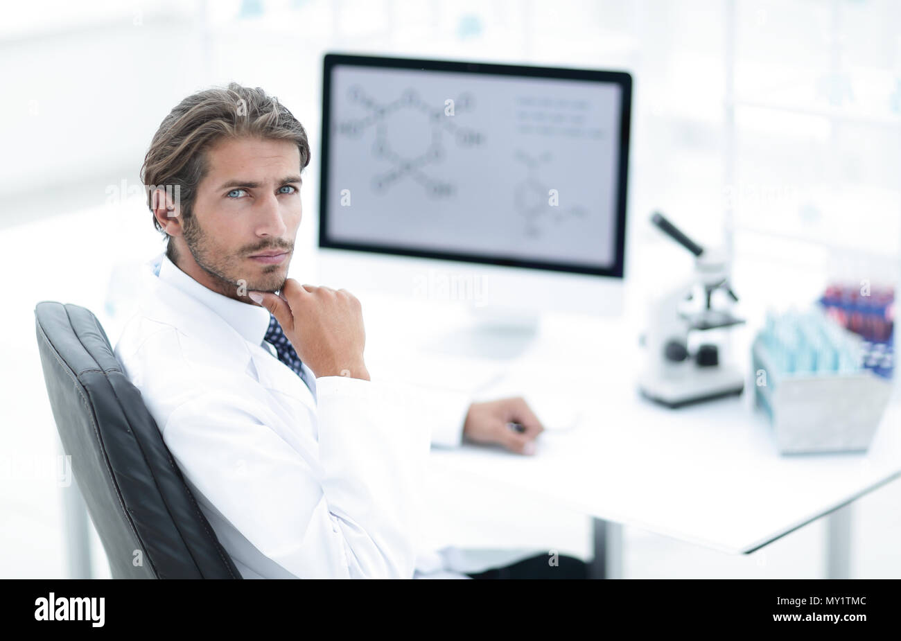 Scientist using computer and microscope in the laboratory Stock Photo ...