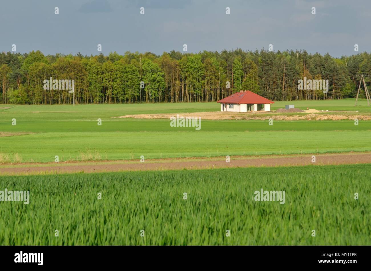 Spring rural landscape. Construction of a new home in the countryside ...