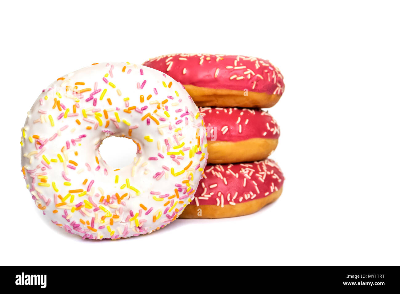 four donuts with a pink icing on a white background Stock Photo - Alamy