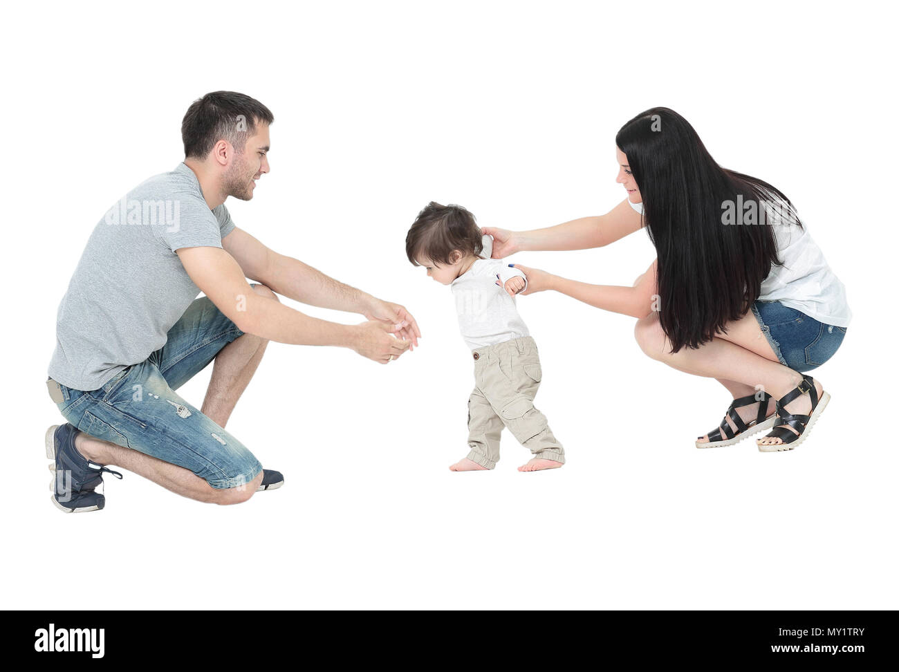 little boy making first steps with the help of parents Stock Photo - Alamy