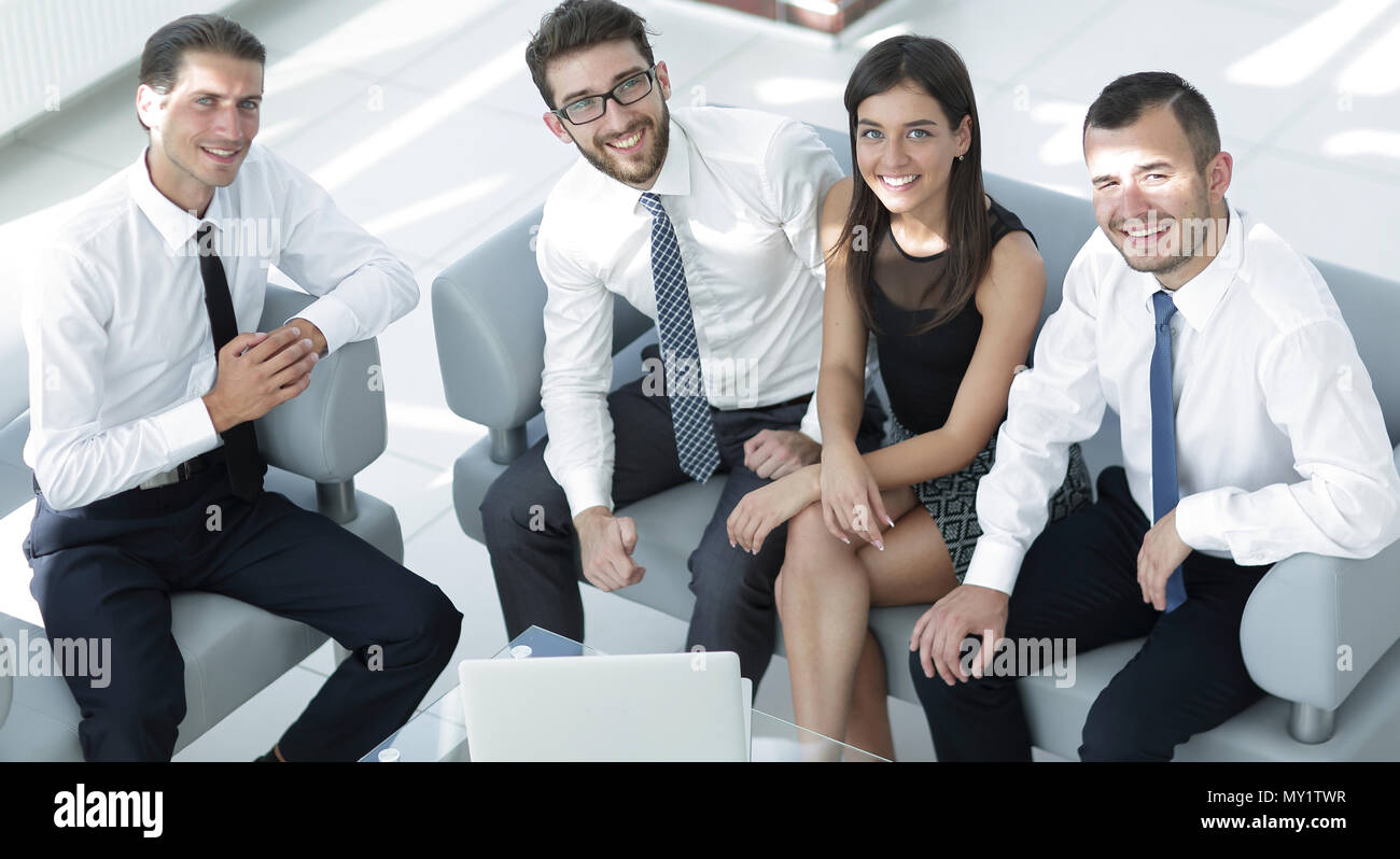 friendly business team sitting in office lobby Stock Photo - Alamy