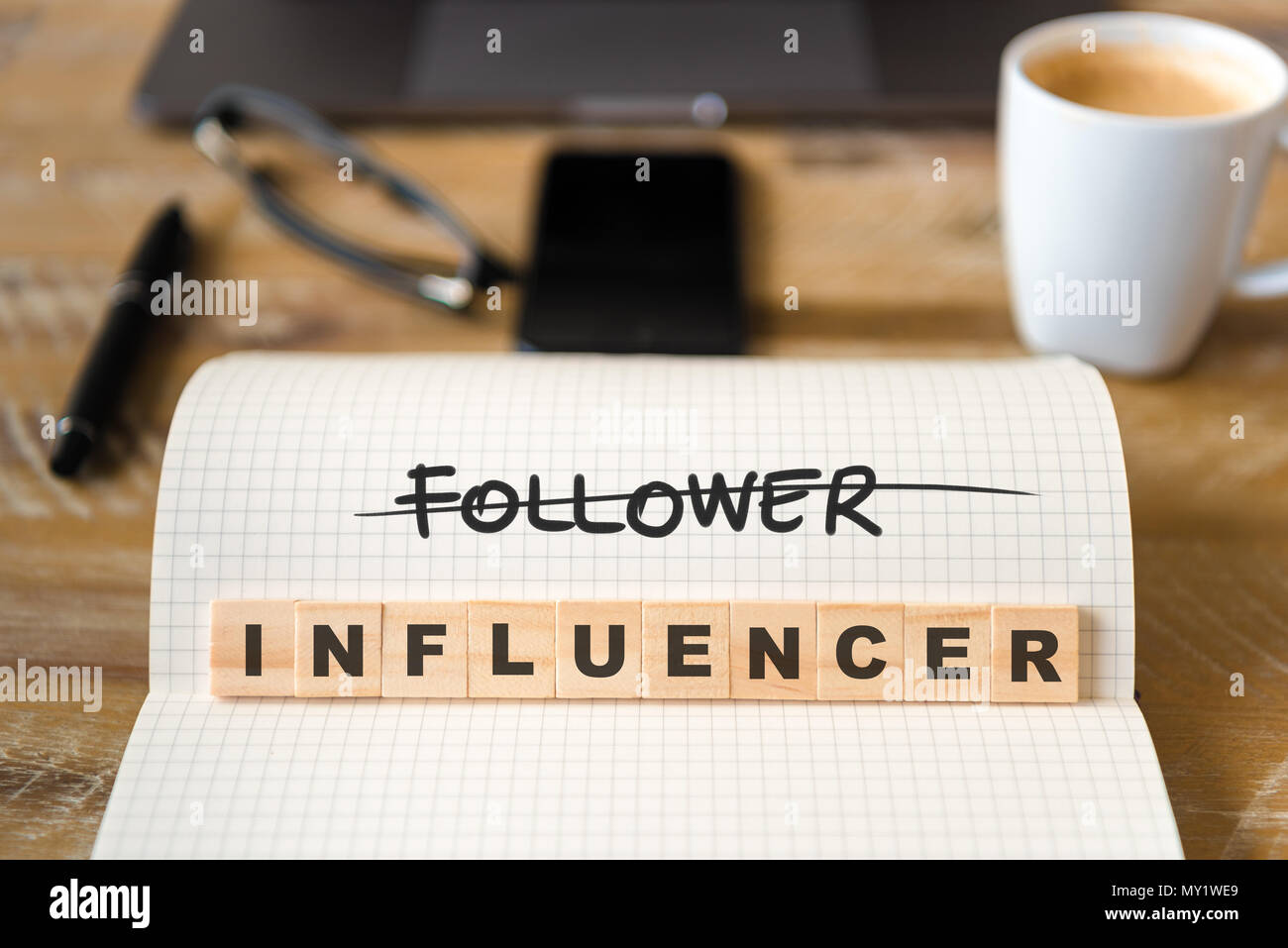 Closeup on notebook over wood table background, focus on wooden blocks ...