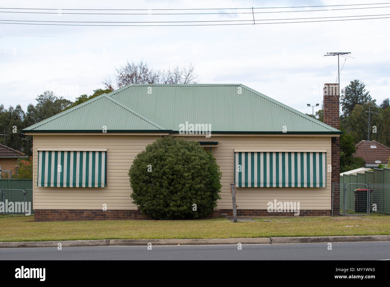 A simple and economically built L Shaped timber and weatherboard clad ...