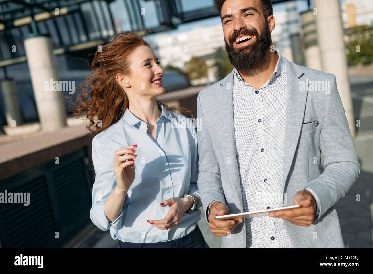 Business people walking and talking outdoor Stock Photo - Alamy